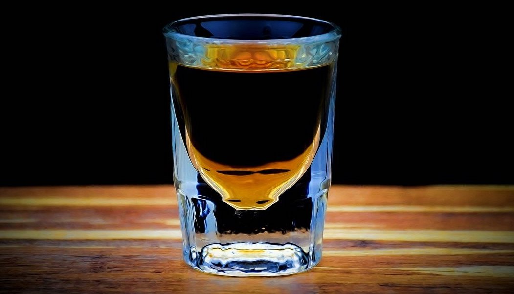 Why Do People Tap Their Shot Glass On A Bar Before Drinking It?