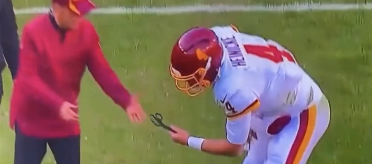 Washington QB Finds Scissors On The Field During The Game (Video)