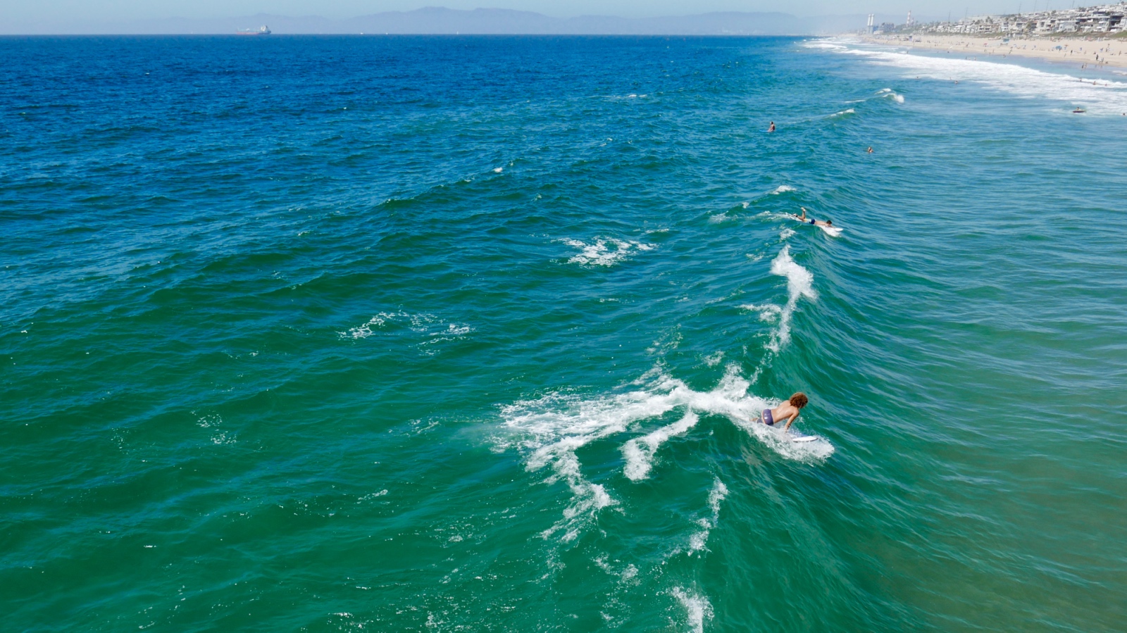 Drone Captures Footage Of Great White Shark Lurking By Surfers