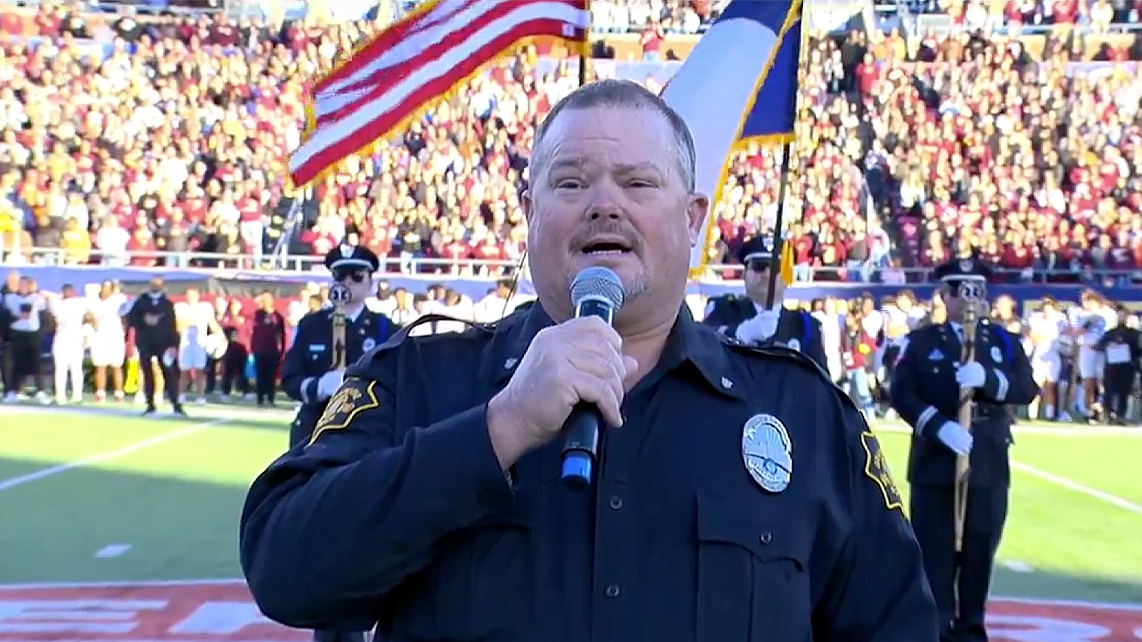 Police Officer Sings Spine-Tingling National Anthem At Bowl Game
